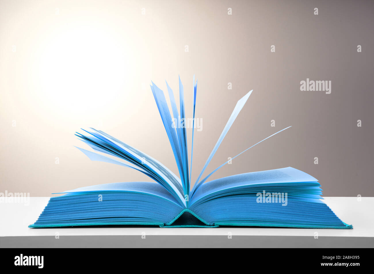 blue open book on the table Stock Photo - Alamy