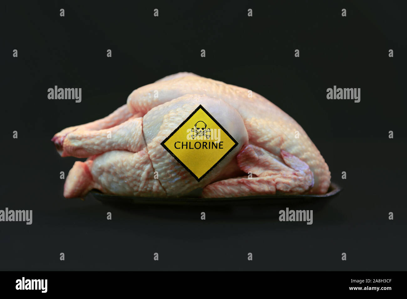 Concept for chlorinated chicken with raw whole chicken with yellow ...