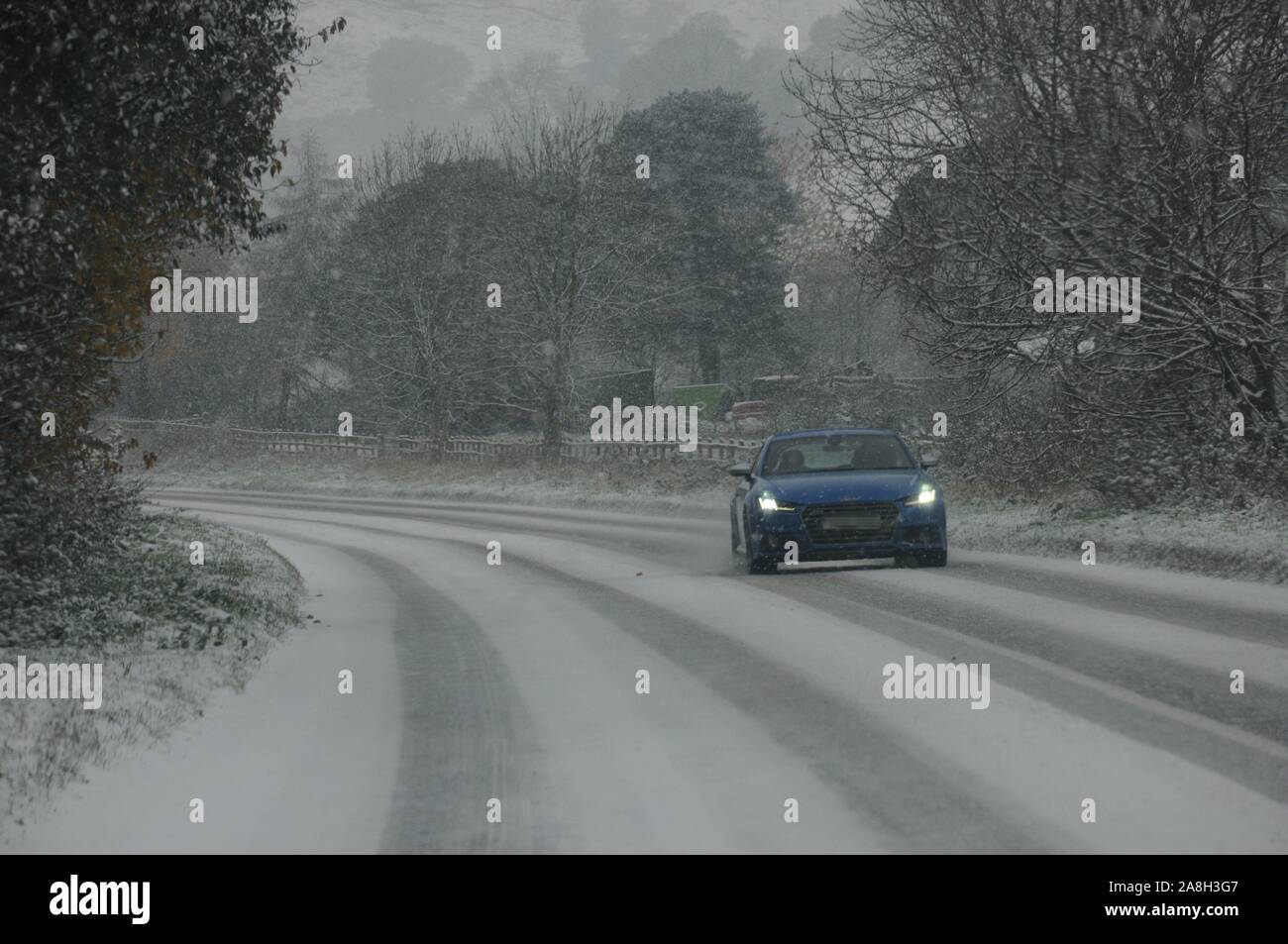 New Radnor, Wales UK, 9th November 2019. A Motorist drives through snow ...