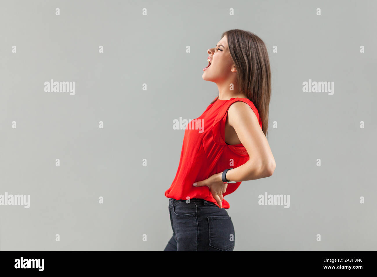 Back ache or pain on kidney. Profile side view portrait of screaming ...