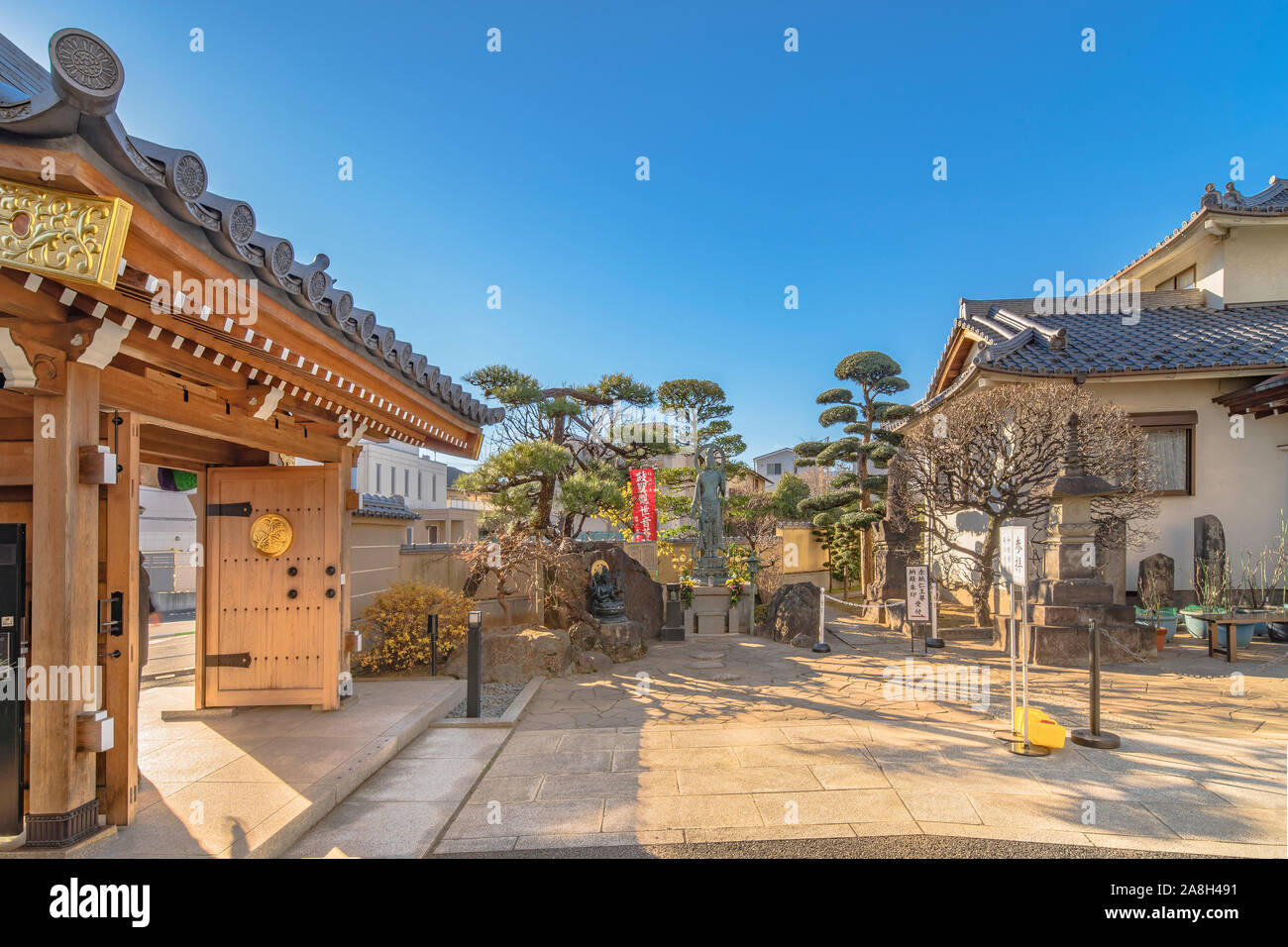Entrance of the Togakuji temple of Tokyo with the golden coat of arms ...