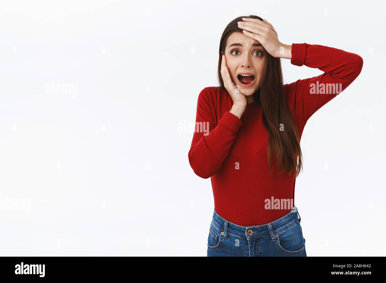 Scared alarmed young brunette girl in red sweater, scream and touching ...