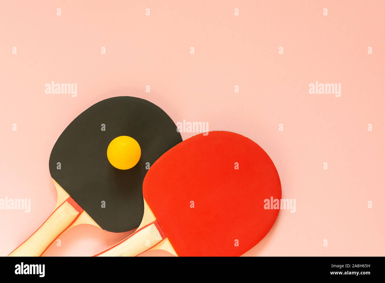 Black and red tennis ping pong rackets and orange ball isolated on a ...