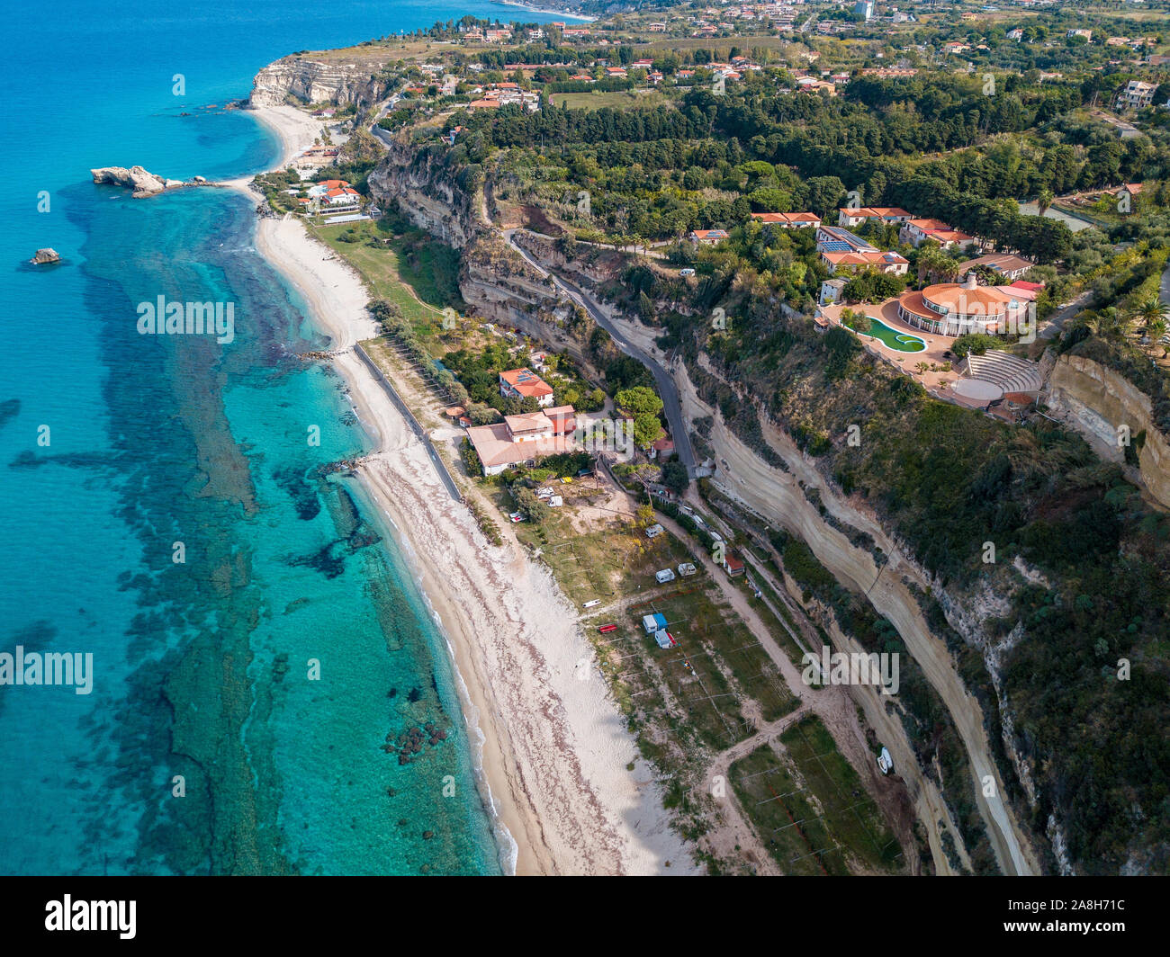 Aerial view of the Calabrian coast, villas and resorts on the cliff ...