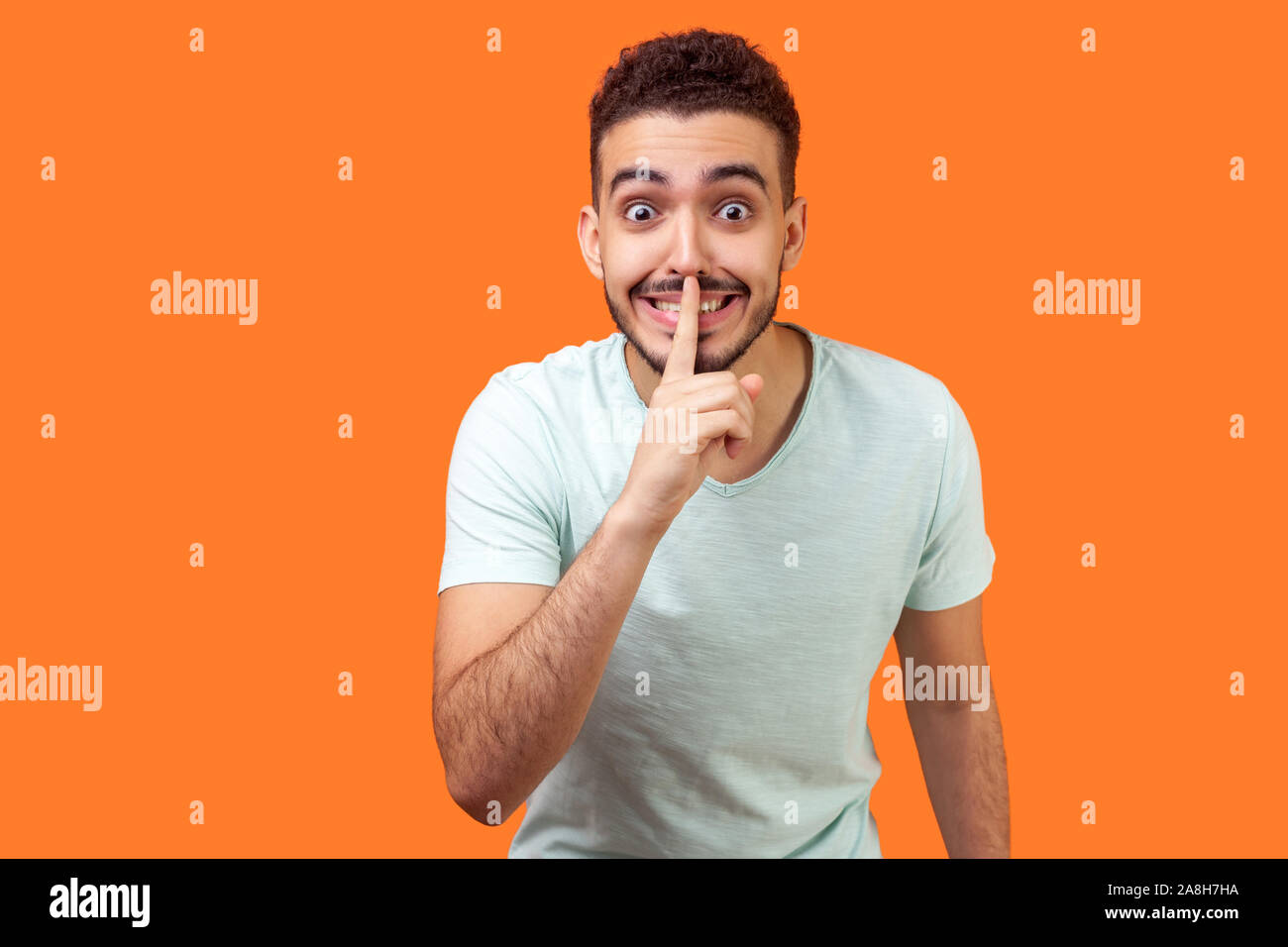 Please, keep silence! Portrait of positive brunette man with beard in ...