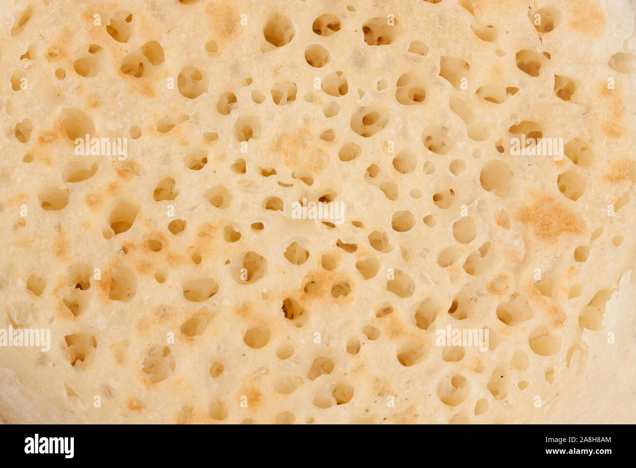 Closeup on the texture of a British breakfast crumpet Stock Photo - Alamy
