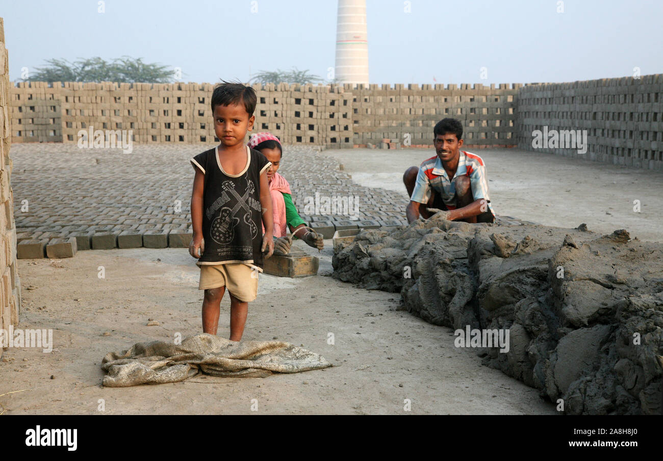 Workers live with their families within the brick factory, where they ...