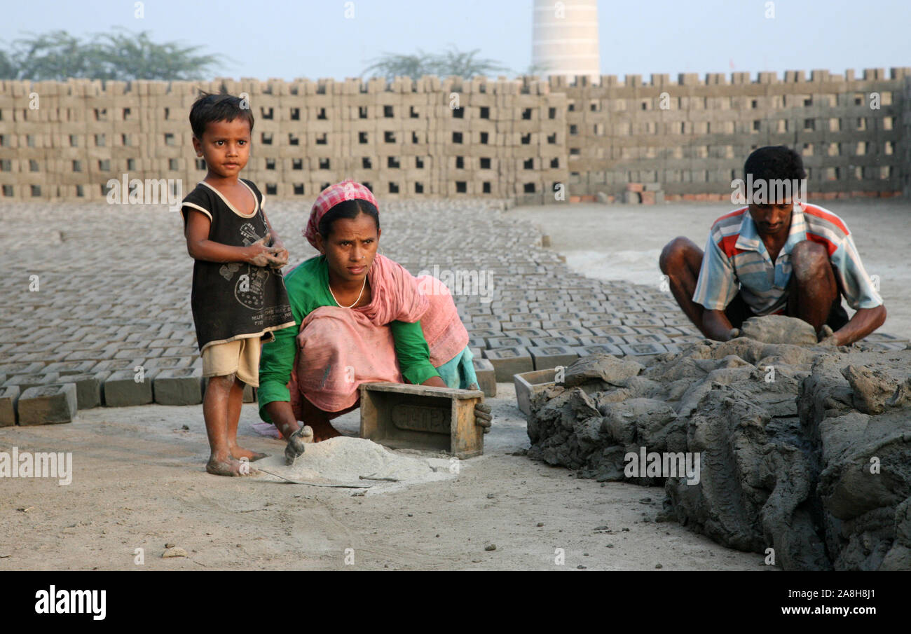 Workers prepare bricks at a brick kiln in Sarberia, West Bengal, India ...