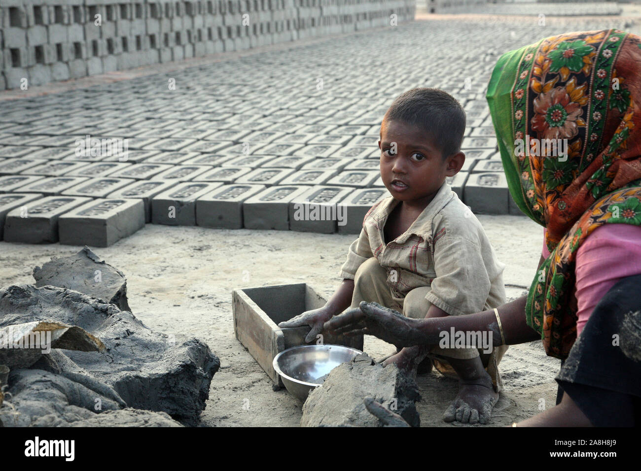 Workers live with their families within the brick factory, where they ...