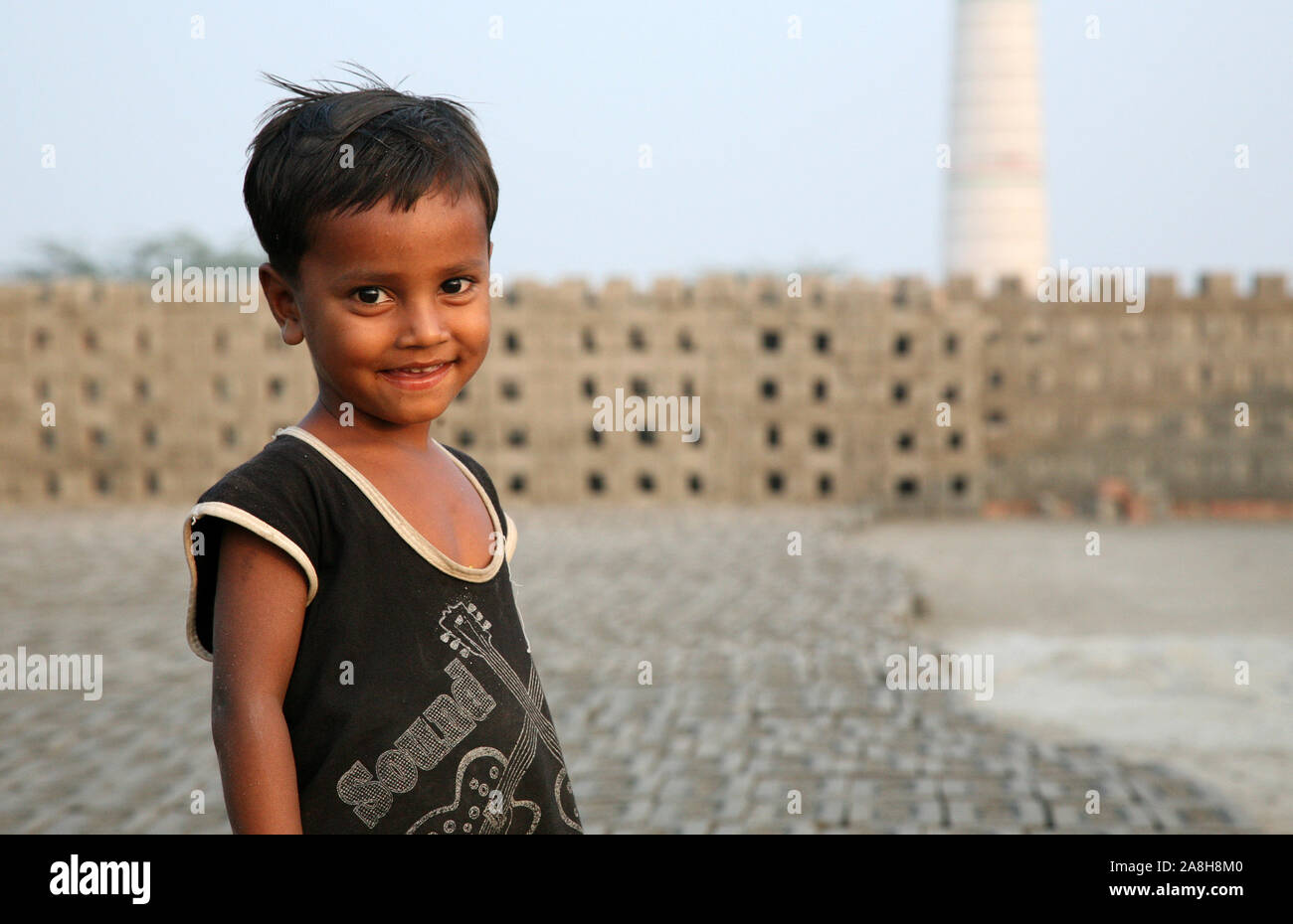 Workers live with their families within the brick factory, where they ...