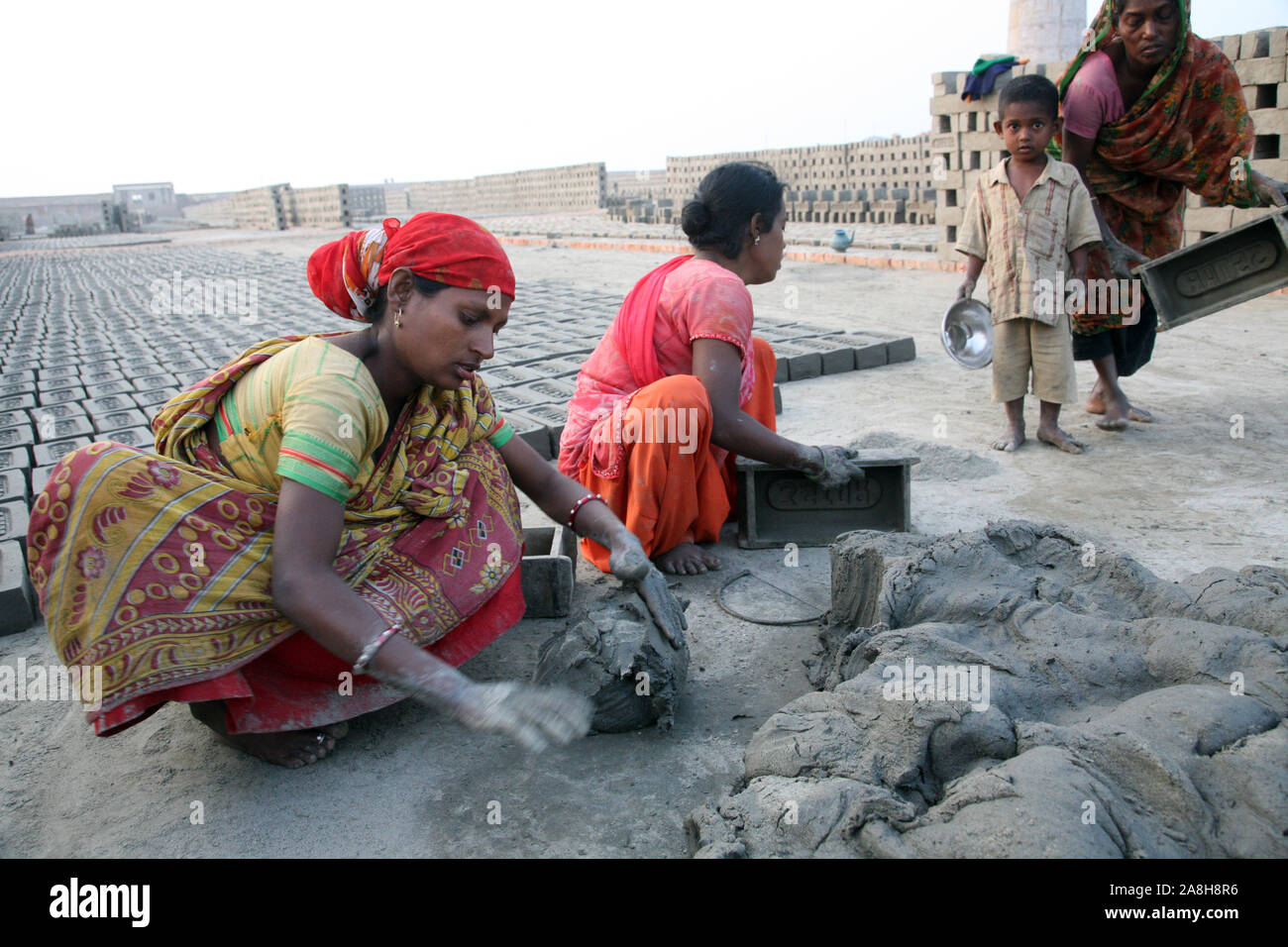 Workers prepare bricks in a brick kiln in Sarberia, West Bengal, India ...