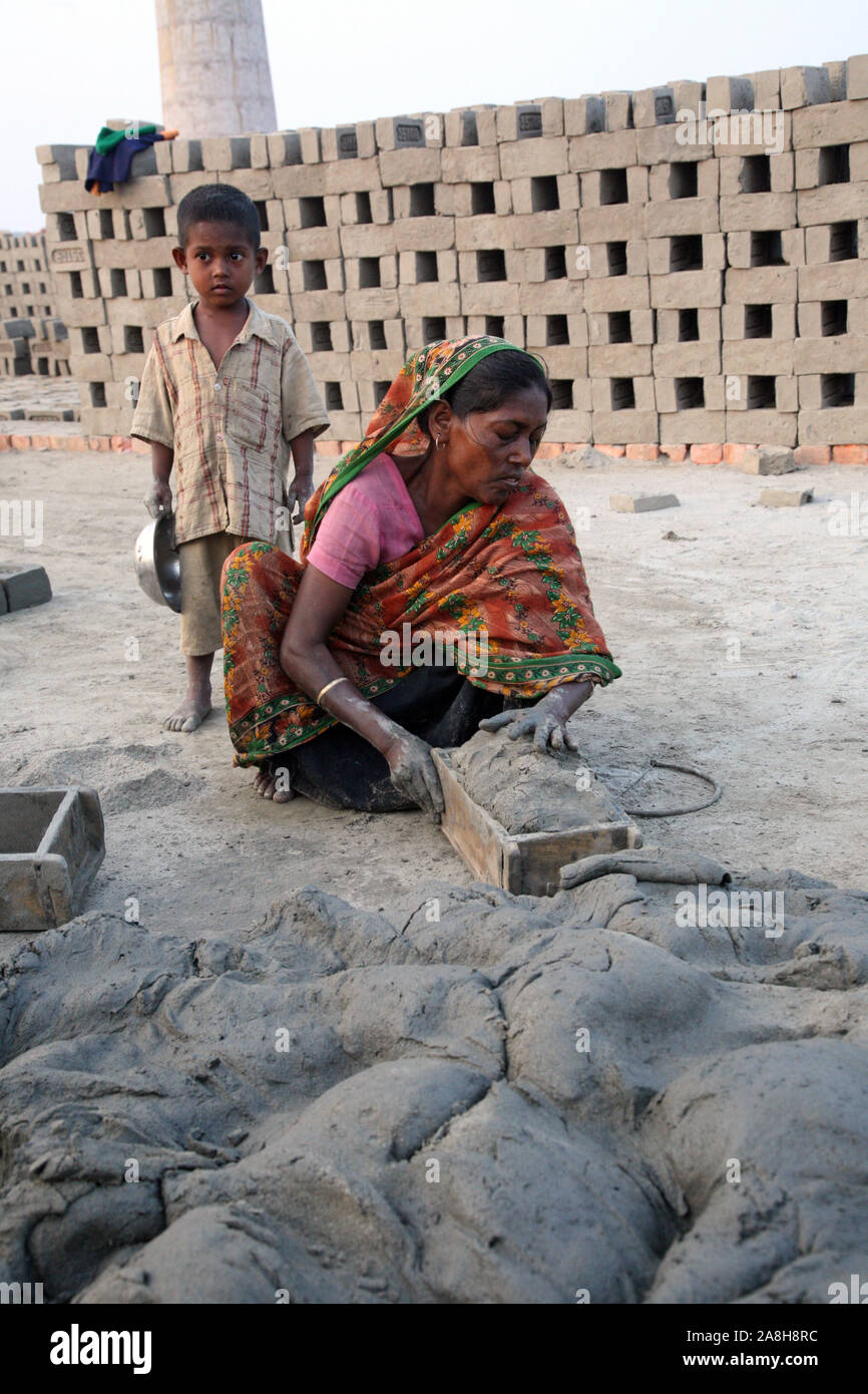 Workers prepare bricks in a brick kiln in Sarberia, West Bengal, India ...