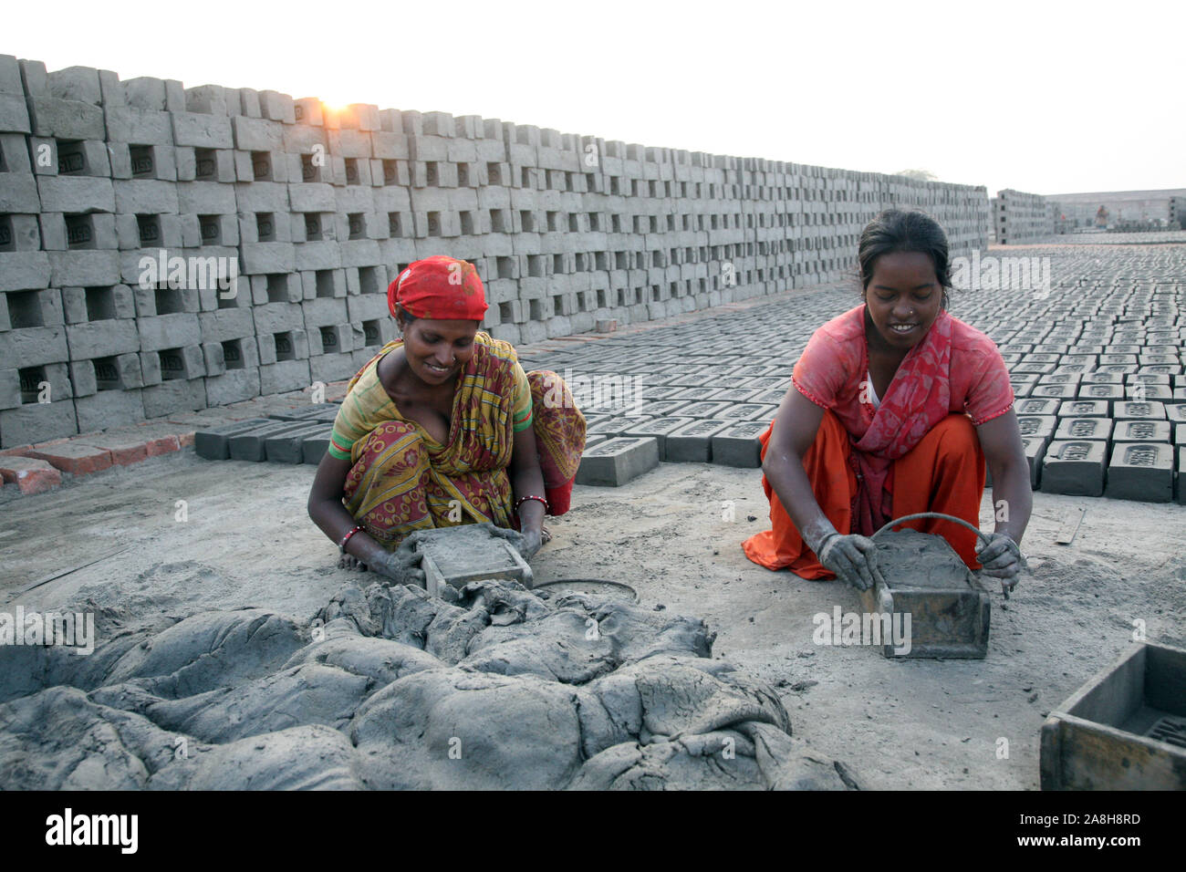 Workers prepare bricks in a brick kiln in Sarberia, West Bengal, India ...