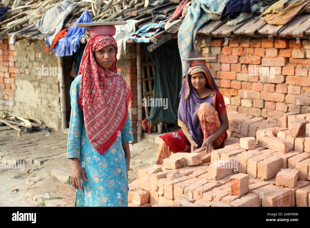 Brick field workers carrying complete finish brick from the kiln in ...