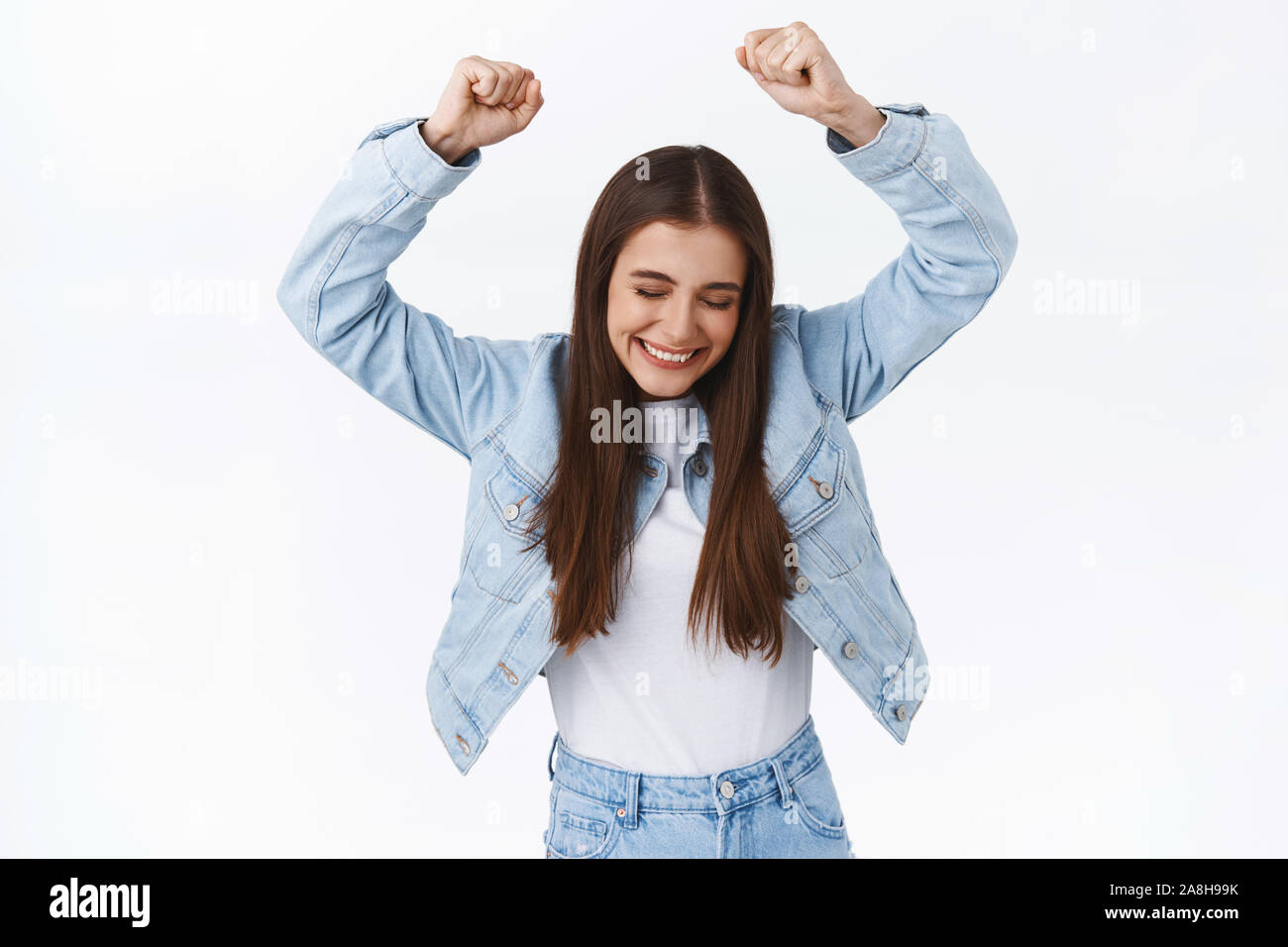 Relieved, joyful happy woman do chamion dance, raising hands up ...