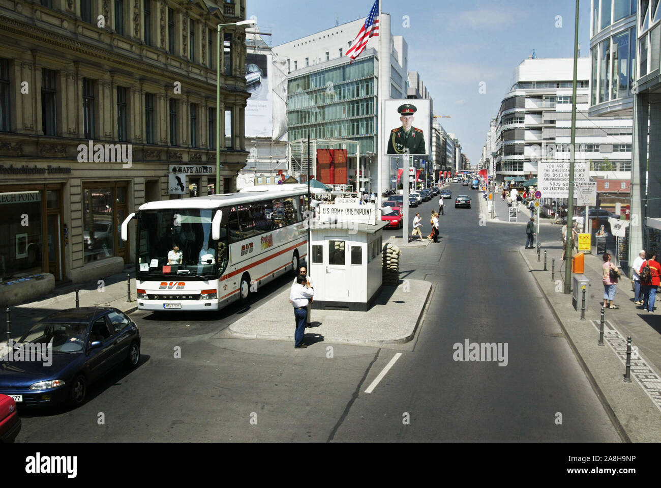 Photography tourist at Checkpoint Charlie, Berlin, which was one of the ...