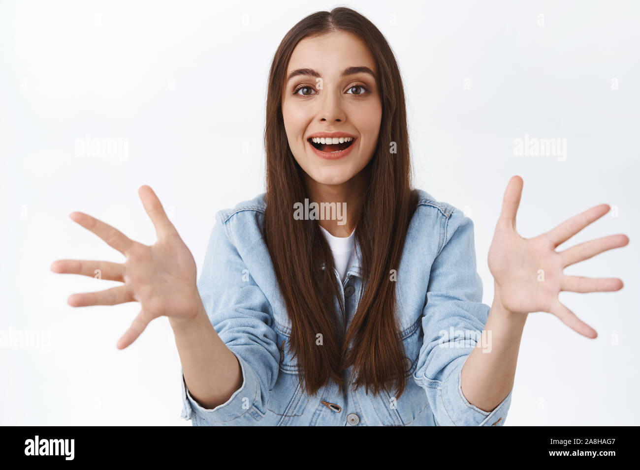 Lovely feminine brunette female, reaching her hands to grab or hold ...