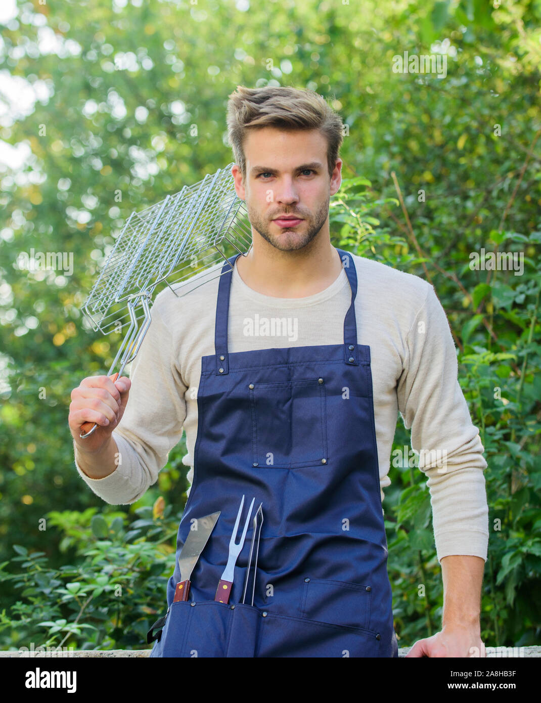 Backyard barbeque party. Man hold grilling grid. Grilling food. Tools ...