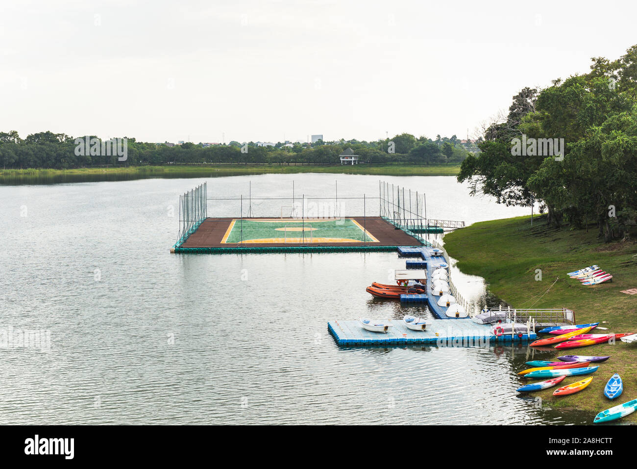 Floating football stadium in the lake with kayak boat in public park ...