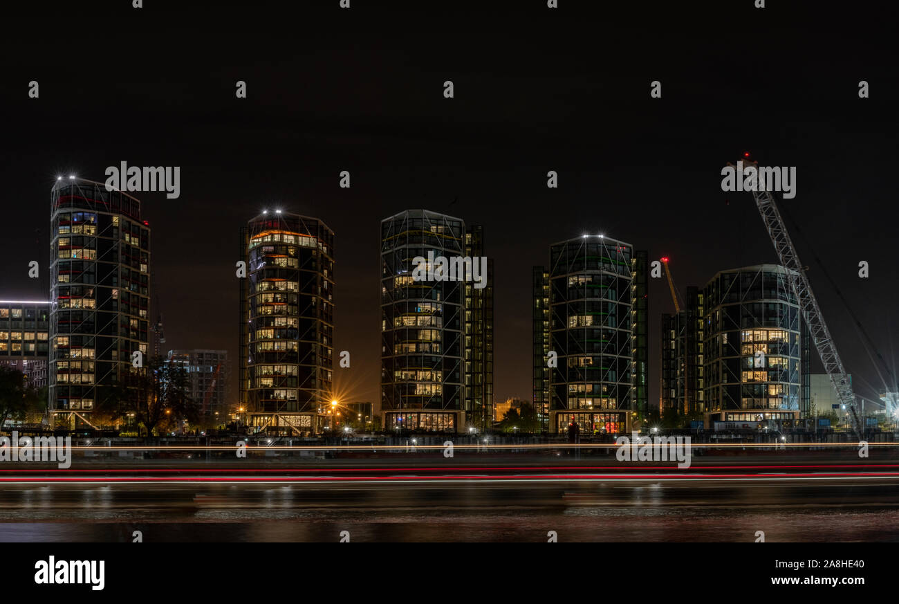 A boat's light trails in front of the flats on Nine Elms Lane, Vauxhall ...