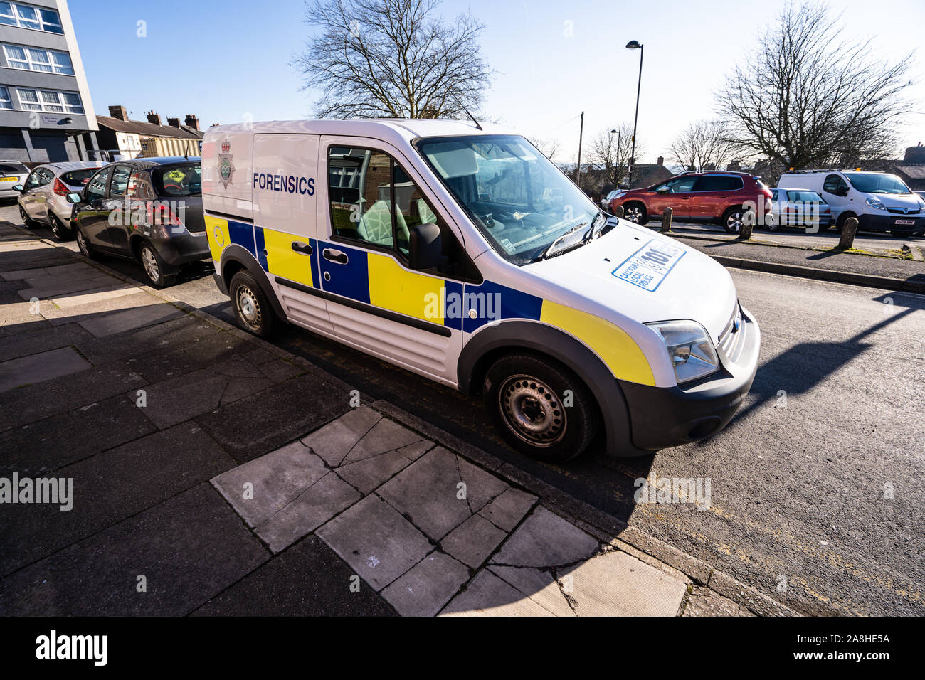 A Forensics van, car parked outside a high rise building, flats near ...