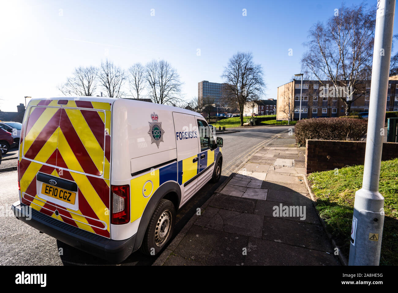 A Forensics van, car parked outside a high rise building, flats near ...