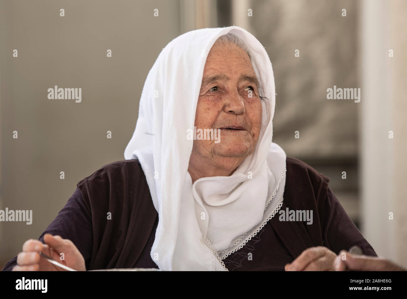 A beautiful, elderly lady living a semi nomadic lifestyle in a village ...