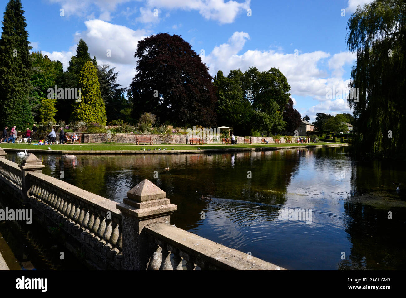 View of the bridge and the serpentine lake at Coombe Abbey Park ...