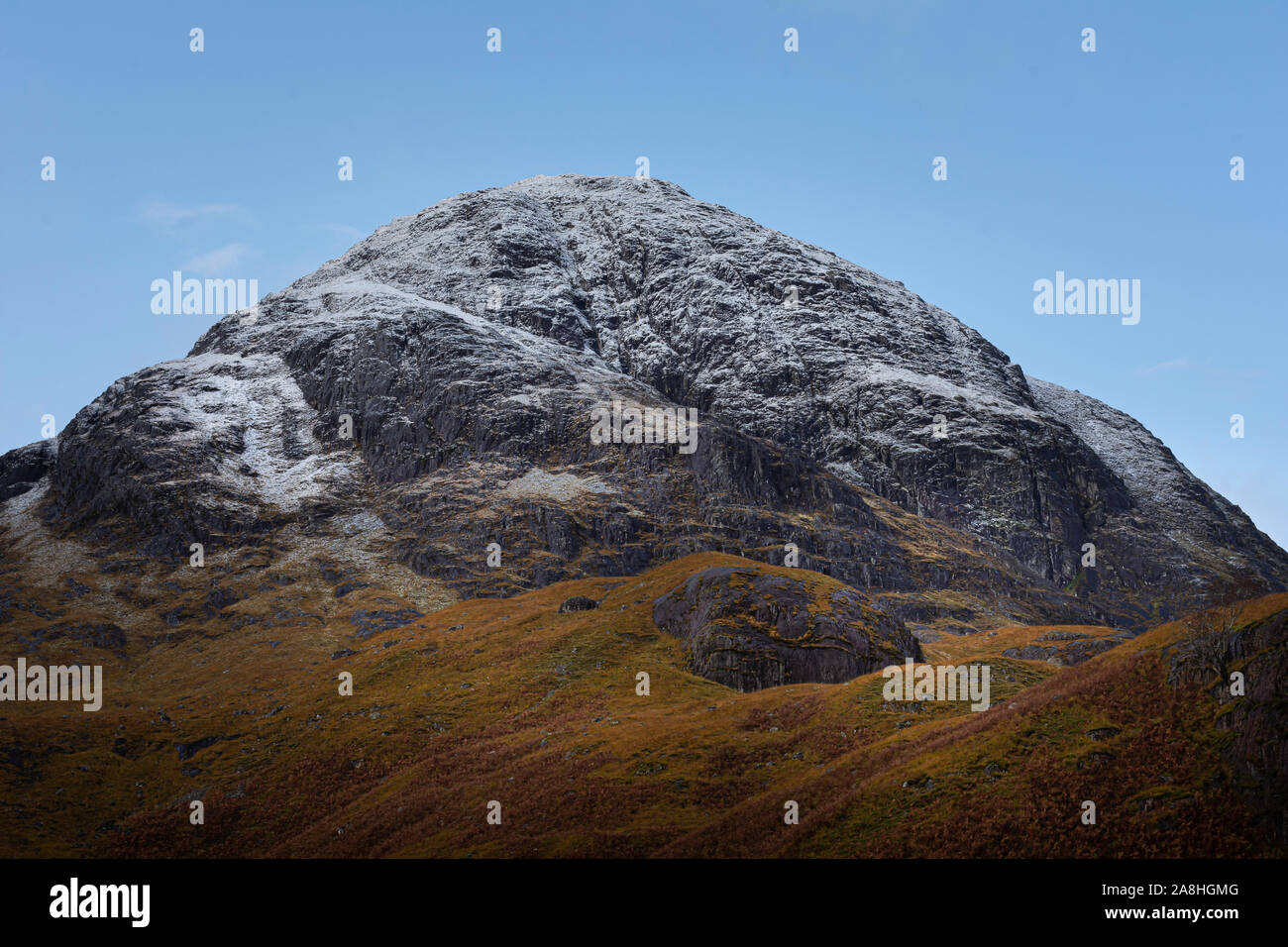 Blue sky above snow capped mountain peak in Scottish highlands and ...