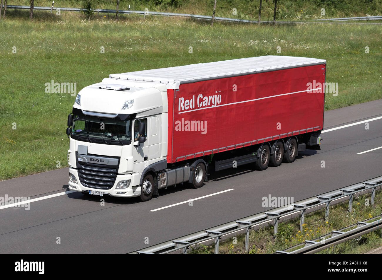 Red Cargo DAF XF truck with curtainside trailer on motorway Stock Photo ...