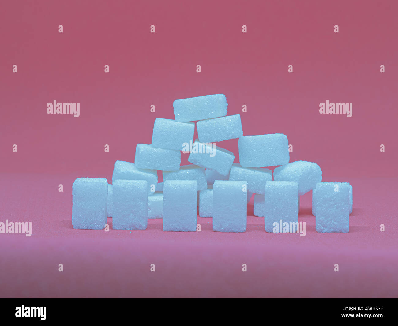 sugar cubes on top another in front of different colors Stock Photo - Alamy