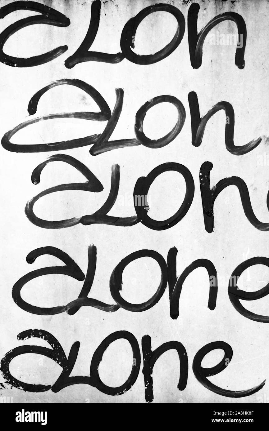 Word "alone" written on grungy wall. It can be used as a poster ...