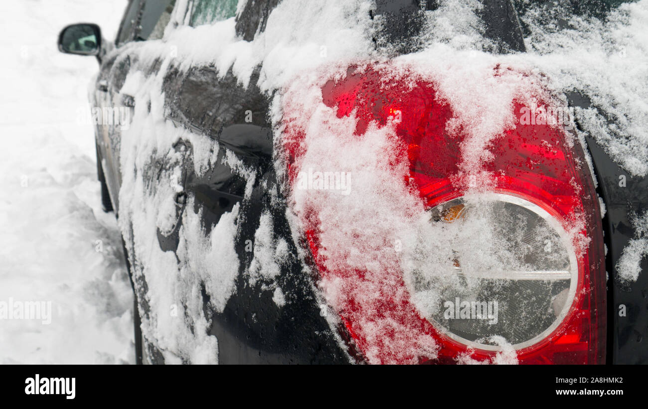 Side view of a modern car covered with snow Stock Photo - Alamy