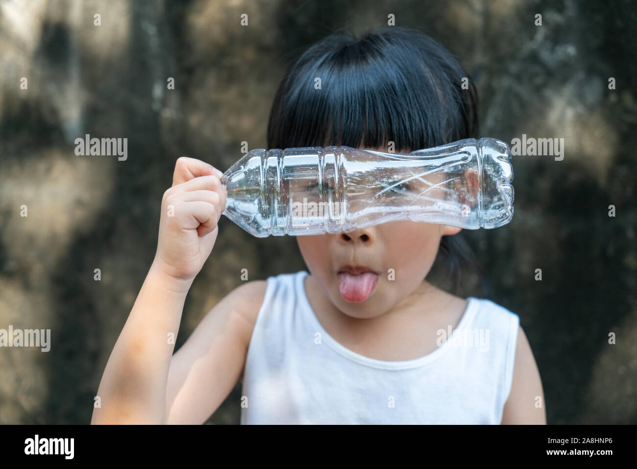 Child girl is acting with plastic bottle. Concept for stop using ...