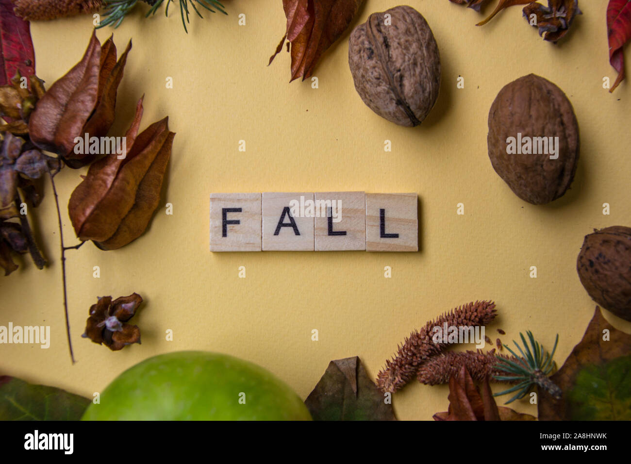 Text spelt with wooden letter tiles on pale yellow background, word ...