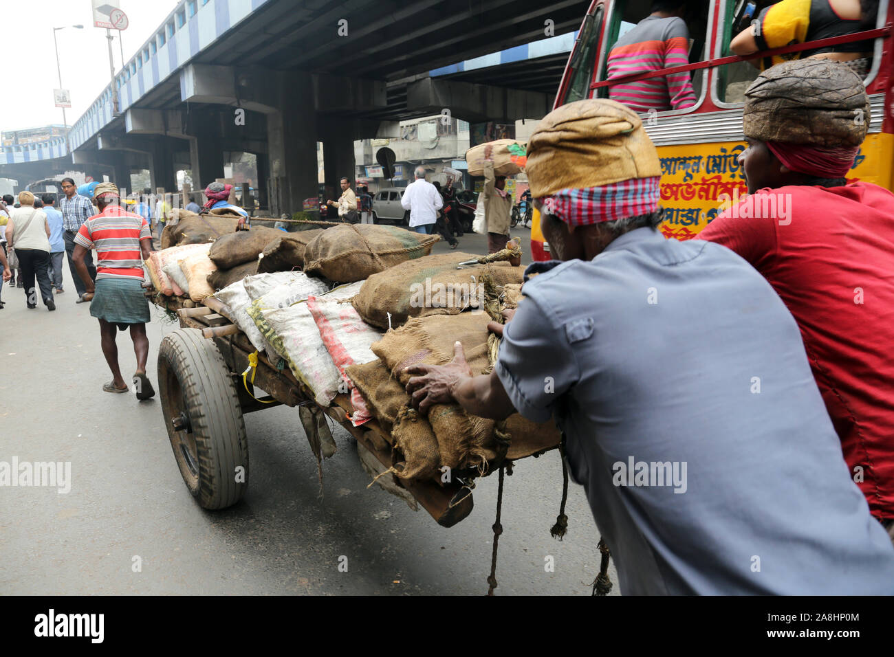Hard working Indians pushing heavy load through streets of Kolkata ...