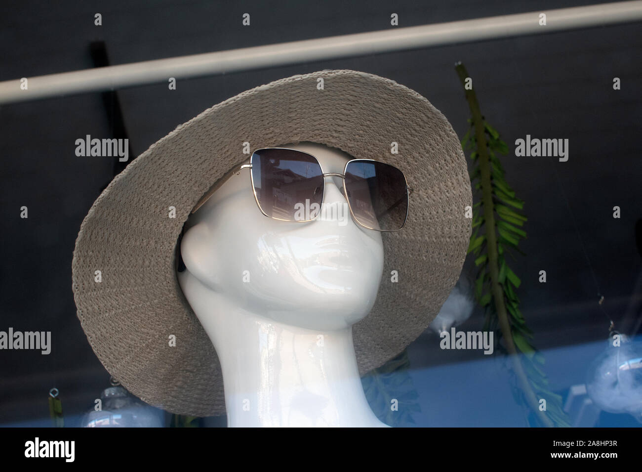 Window display of hat on mannequin head Stock Photo - Alamy