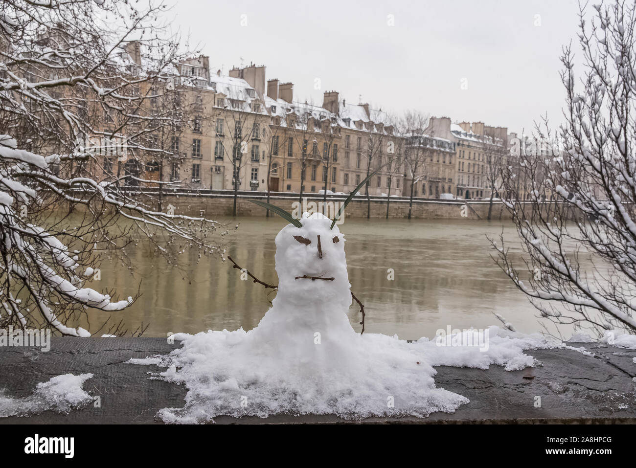 Paris under the snow and floods, snowman on the bank of the Seine ...