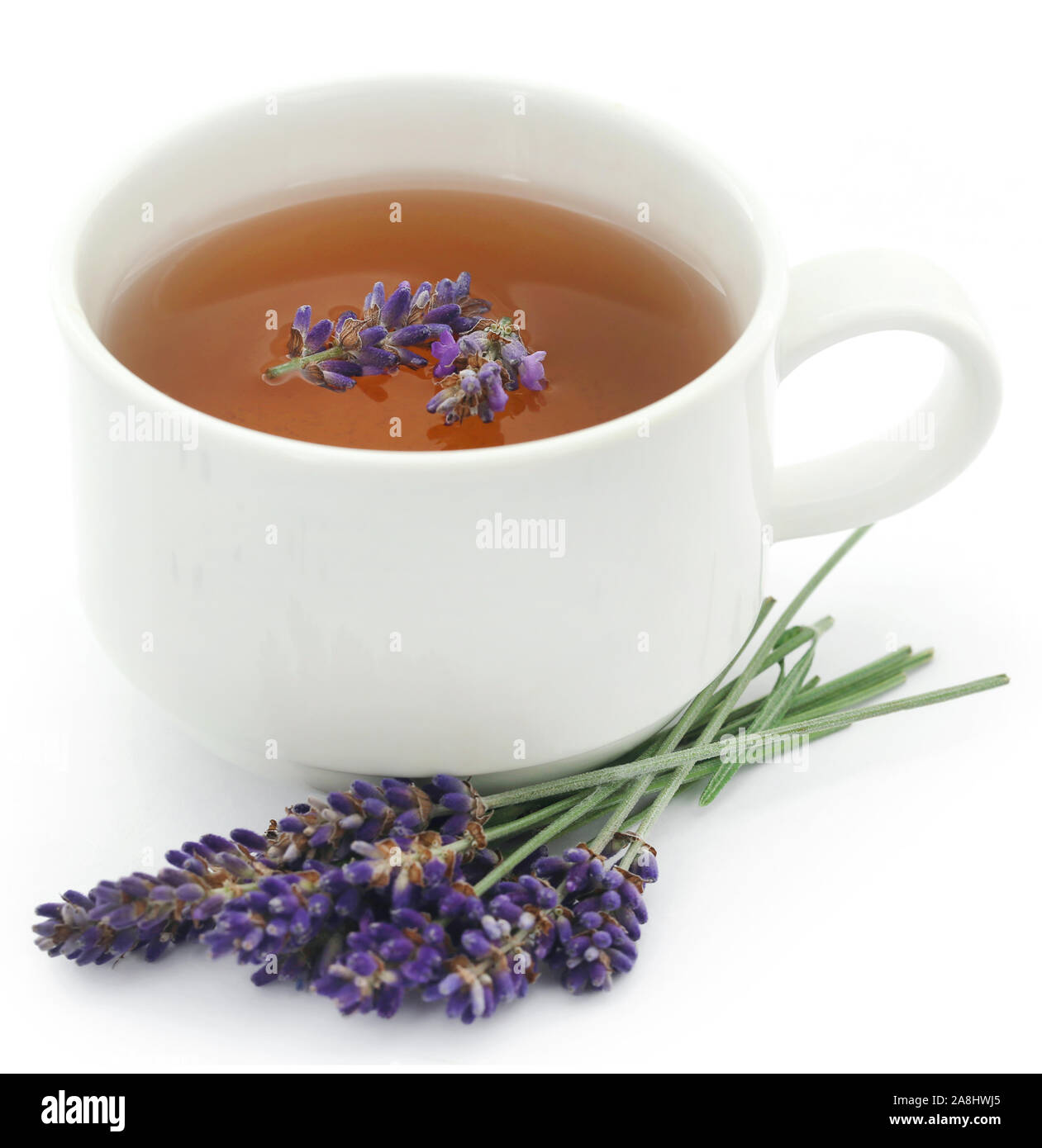 Lavender tea with flower over white background Stock Photo - Alamy