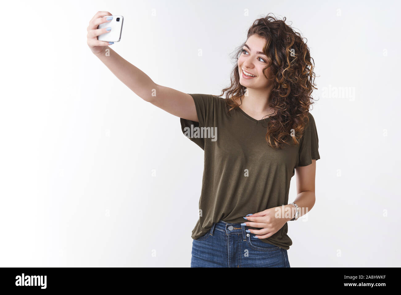 Attractive confident easy-going female blogger taking selfie wanna post ...