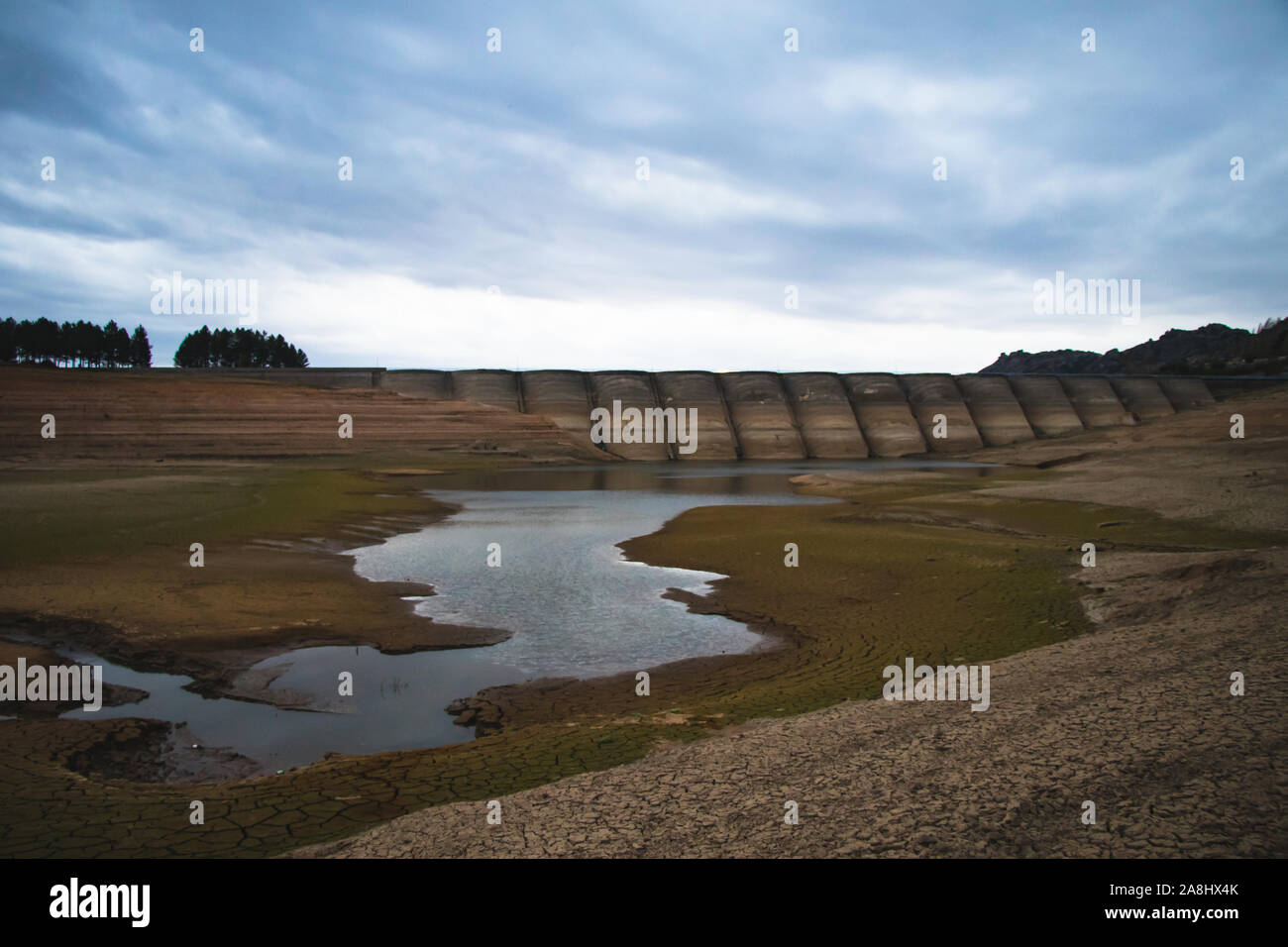 Dam and a small lake in an arid dried out ground. Desert. Global ...