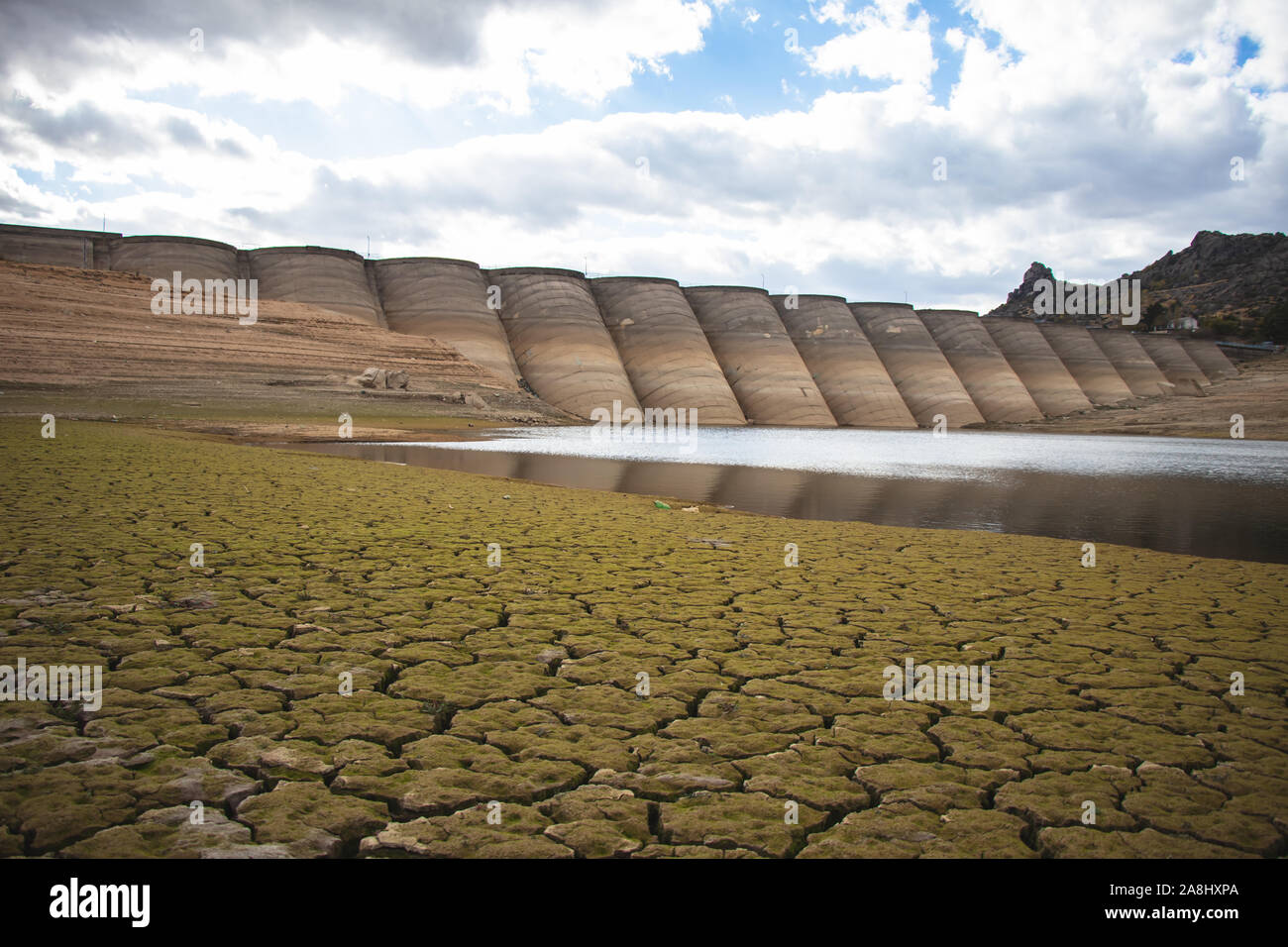 Dam and a small lake in an arid dried out ground. Desert. Global ...