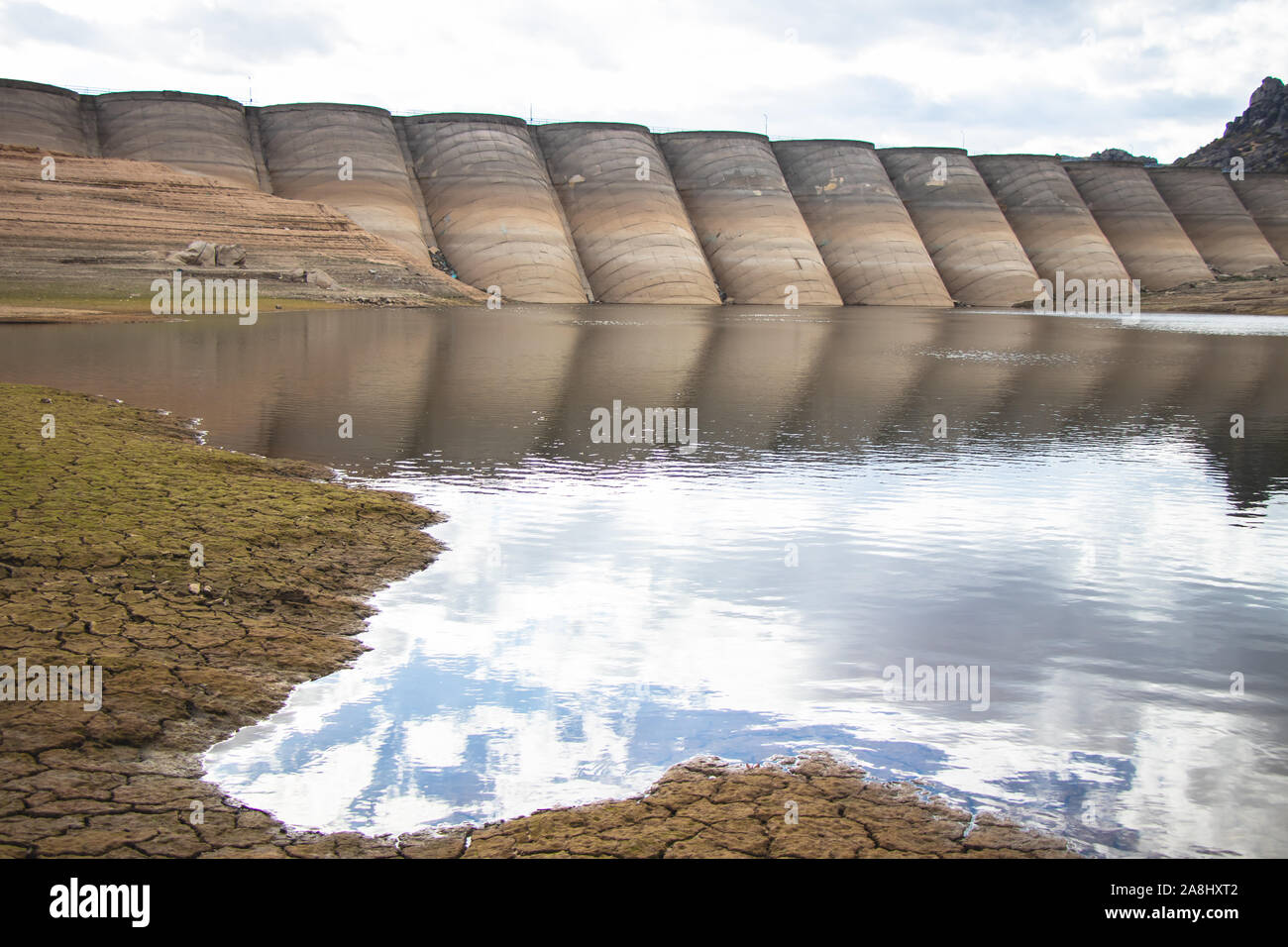 Dam and a small lake in an arid dried out ground. Desert. Global ...
