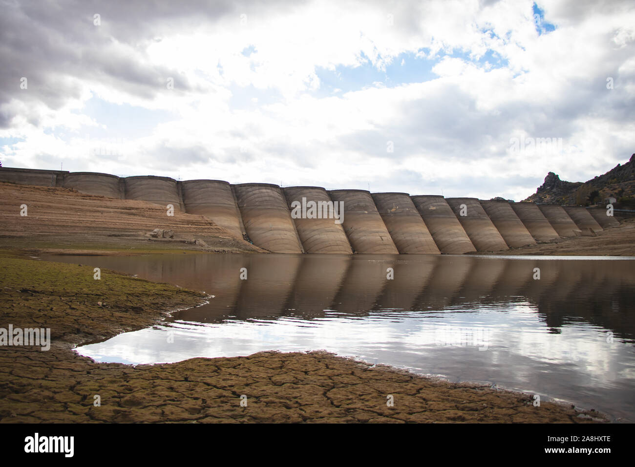 Dam and a small lake in an arid dried out ground. Desert. Global ...