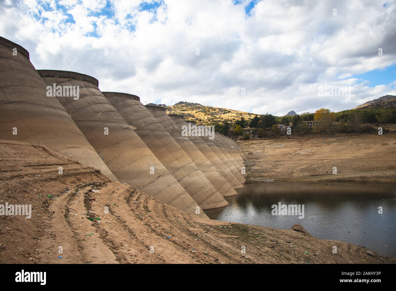 Dam and a small lake in an arid dried out ground. Desert. Global ...