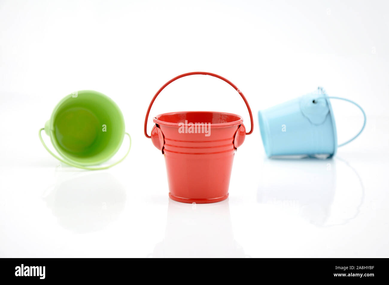 Three metal buckets of different colours with handle, isolated on white ...