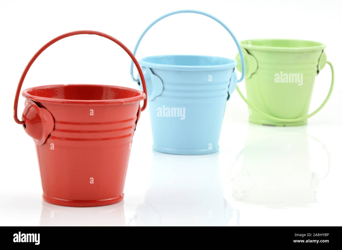 Three metal buckets of different colours with handle, isolated on white ...