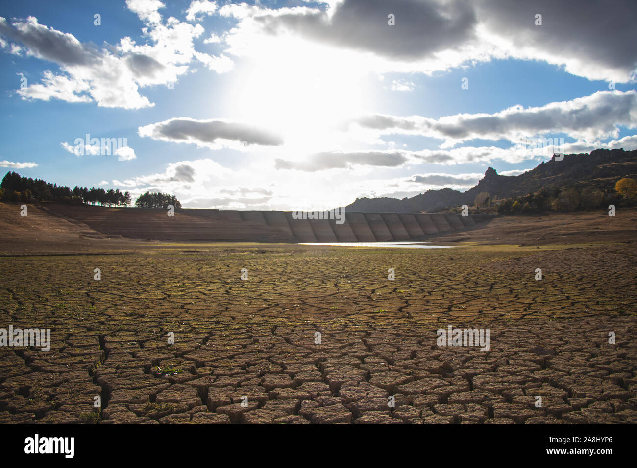 Dam and a small lake in an arid dried out ground. Desert. Global ...