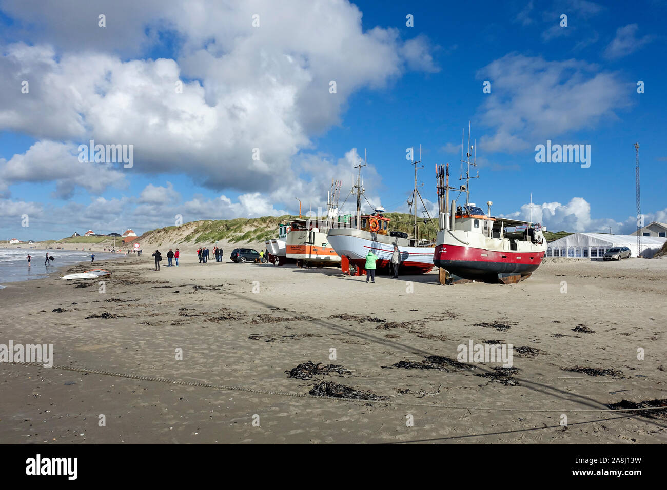 Fishing boats on the sandy beach at small town Løkken by the North Sea ...