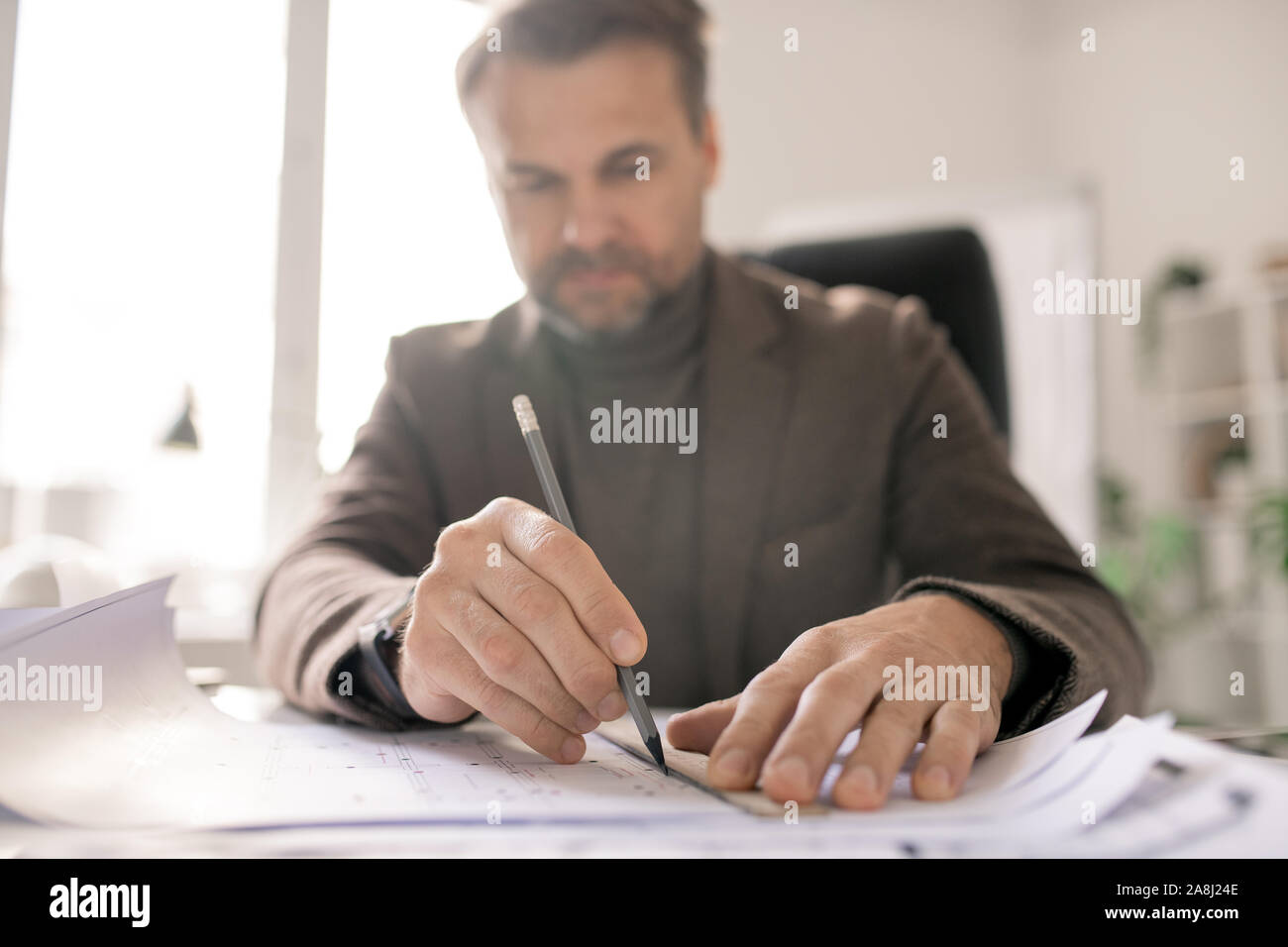 Hands of architect with pencil and ruler drawing line while making ...